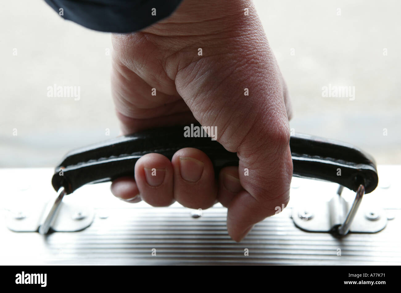 hand holding protective briefcase with leather handle Stock Photo - Alamy