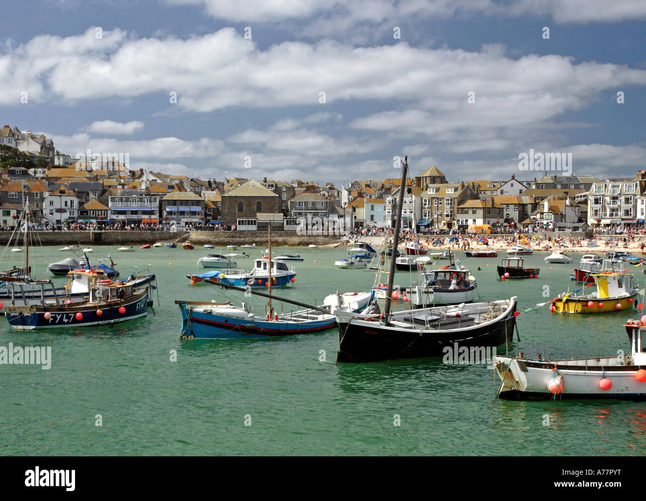 St Ives harbour with boats along seaside,Cornwall England, UK Stock ...