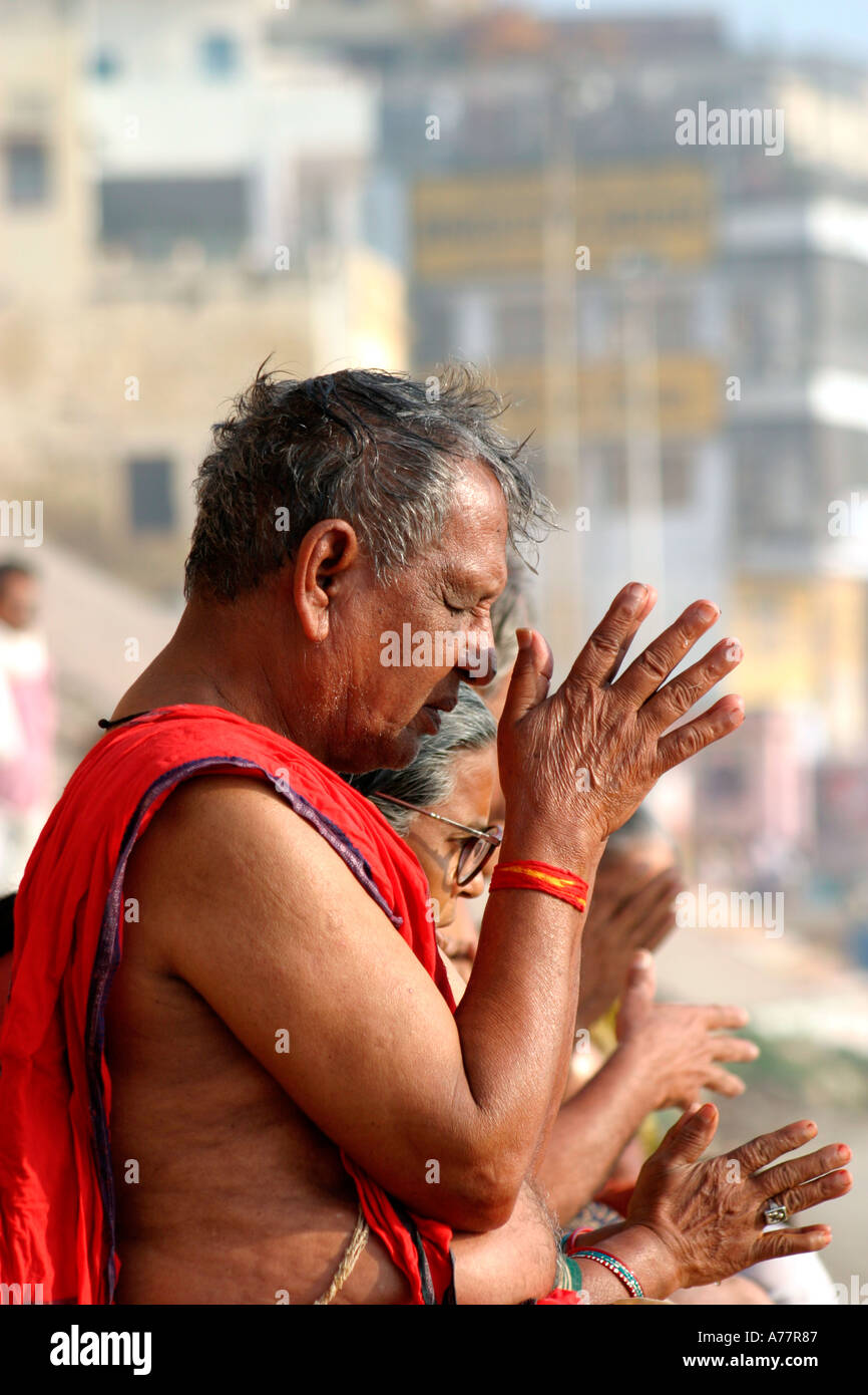 man praying beside the ganges in india Stock Photo - Alamy