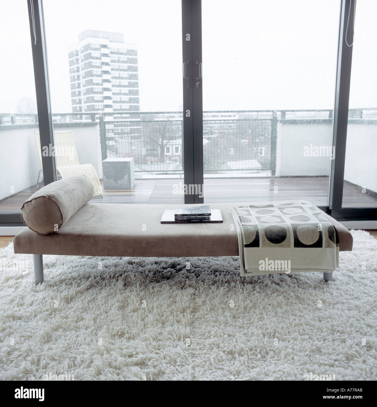 contemporary chaise longue lounger in window of room Stock Photo - Alamy