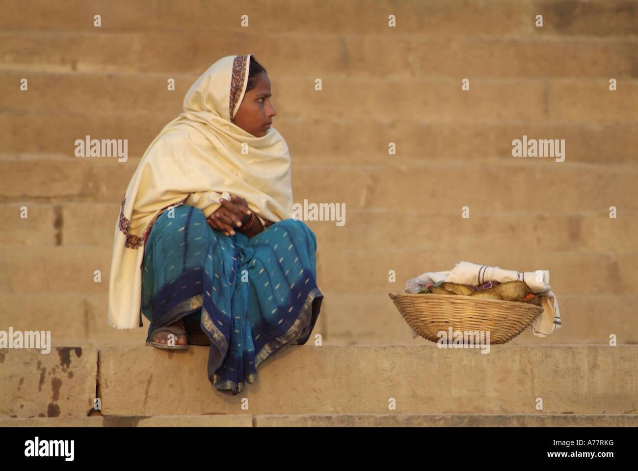 Woman sitting at a Ghat in Varanasi India Stock Photo - Alamy