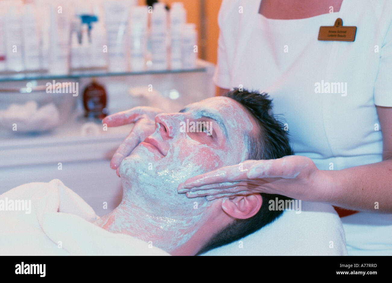 Man gets face mask applied Stock Photo - Alamy