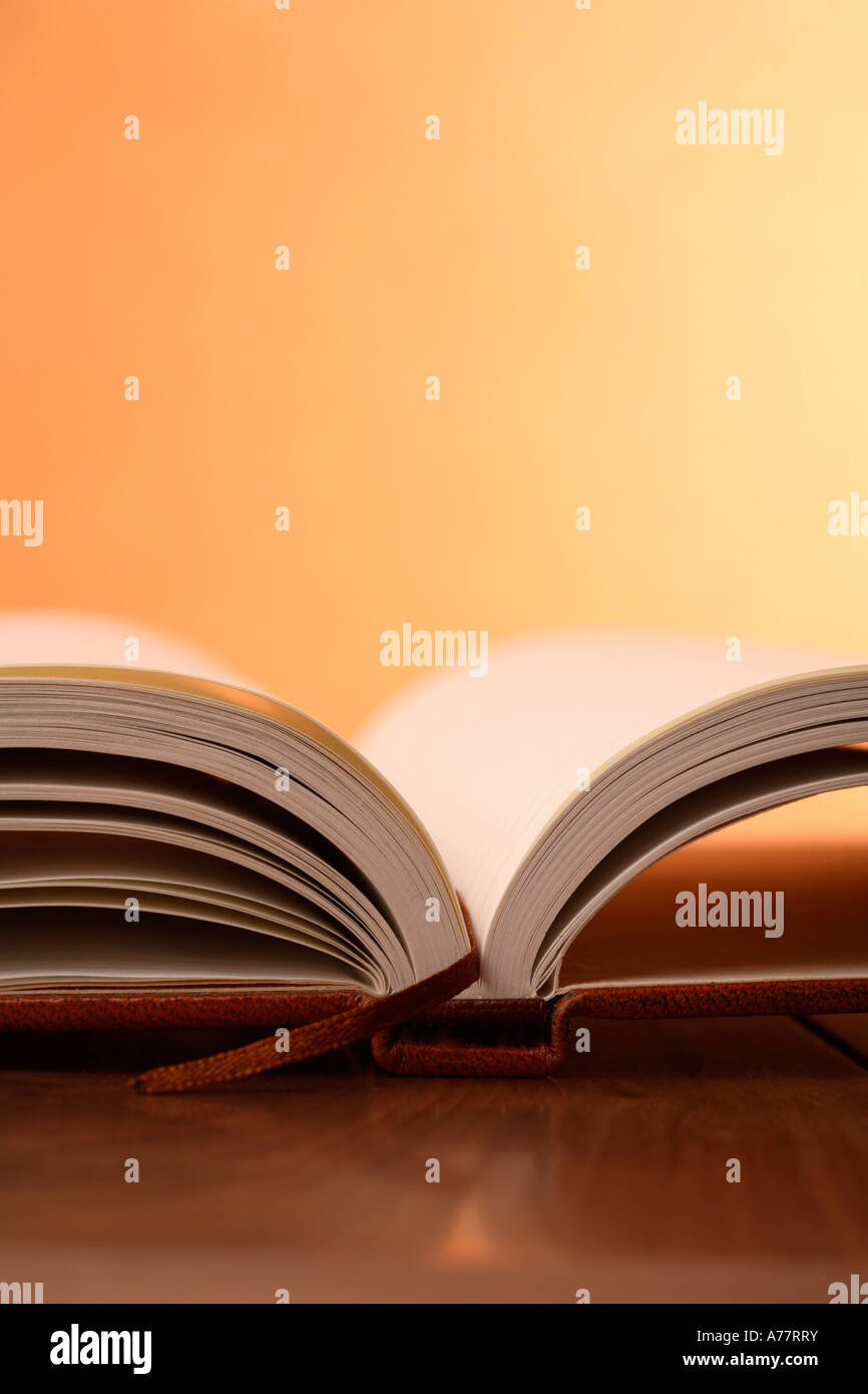 Open leather bound book with warm background Stock Photo - Alamy