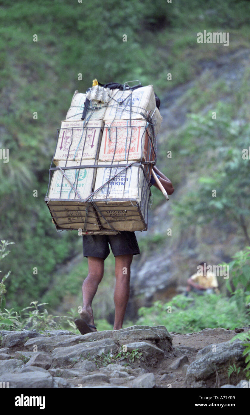Nepali porter carrying goods to sell in high mountain places in ...