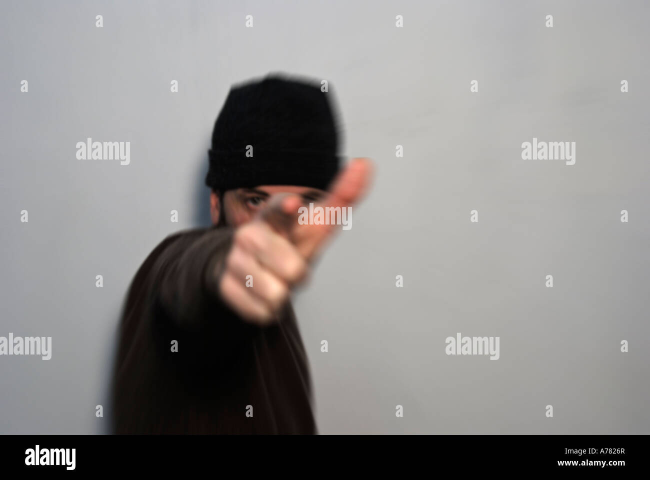 youngster with hat hand making pistol gun sign Stock Photo - Alamy
