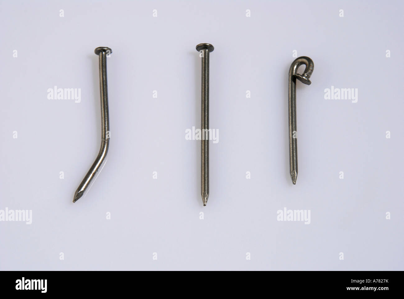 straight and bent nails on white background Stock Photo - Alamy