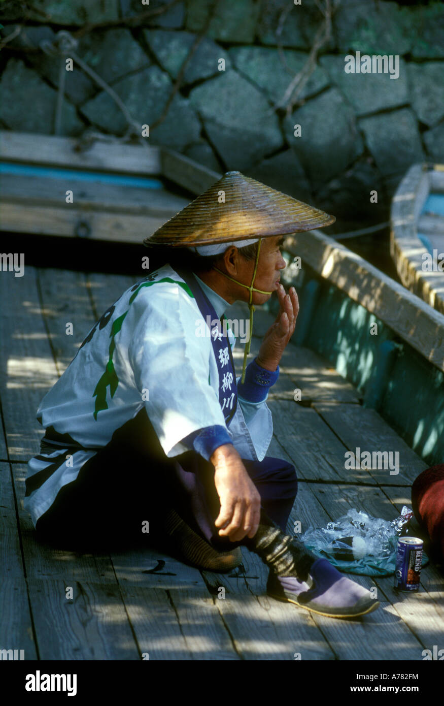 japanese man eating bento box lunch Yanagawa river Kyushi island Japan ...
