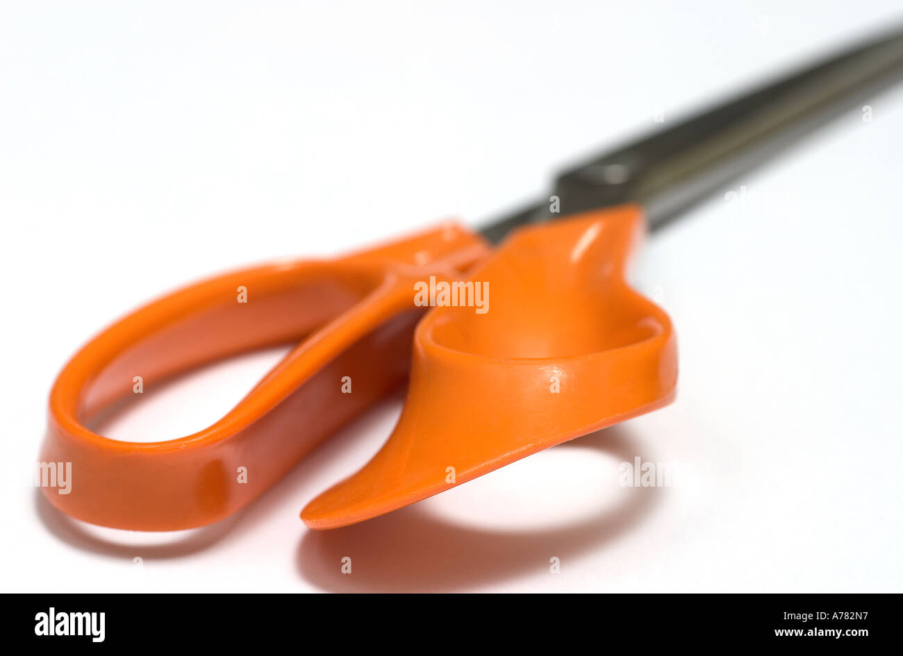 Orange handle scissors on a white background Stock Photo - Alamy