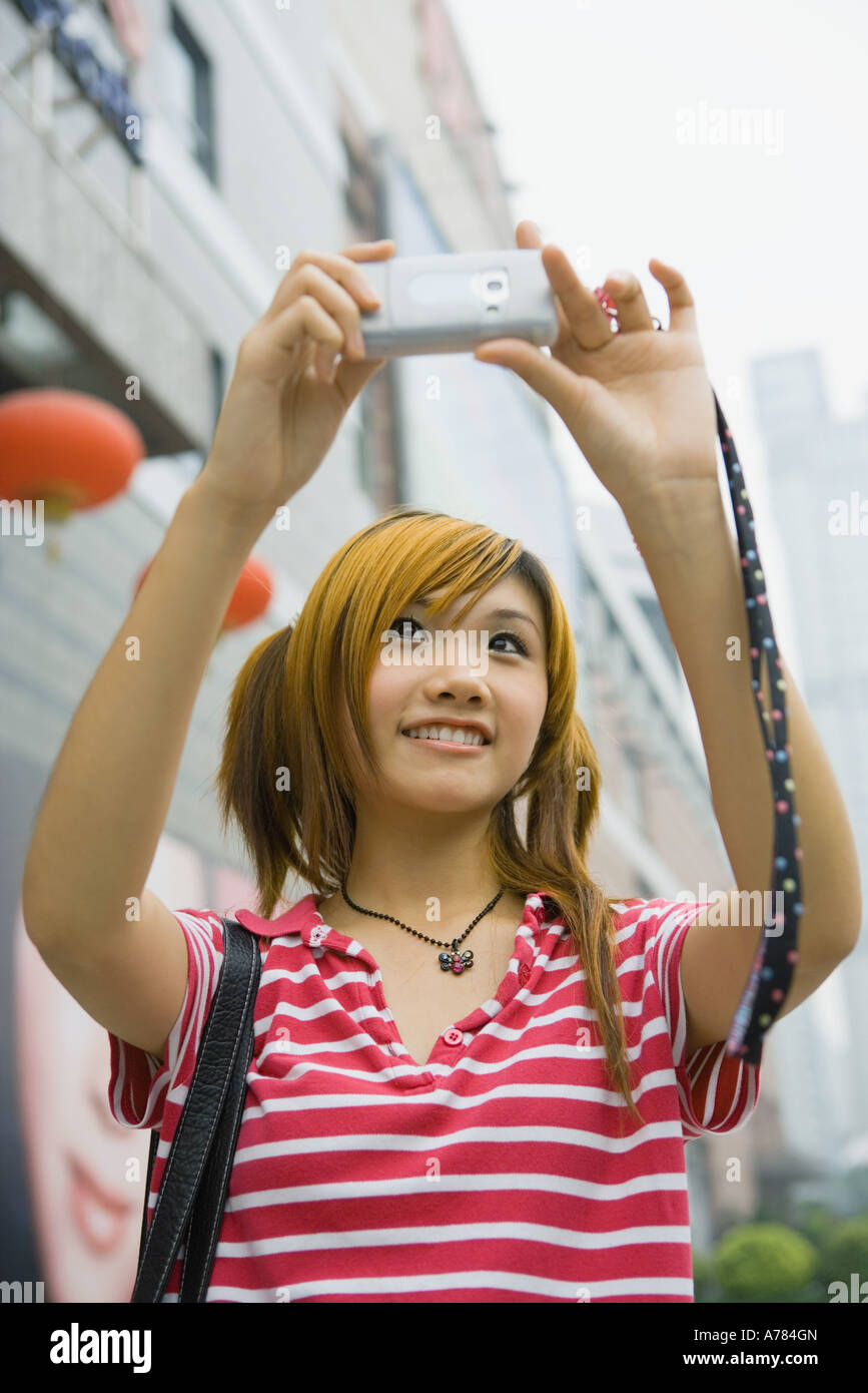 Teenage girl taking photo with cell phone Stock Photo - Alamy