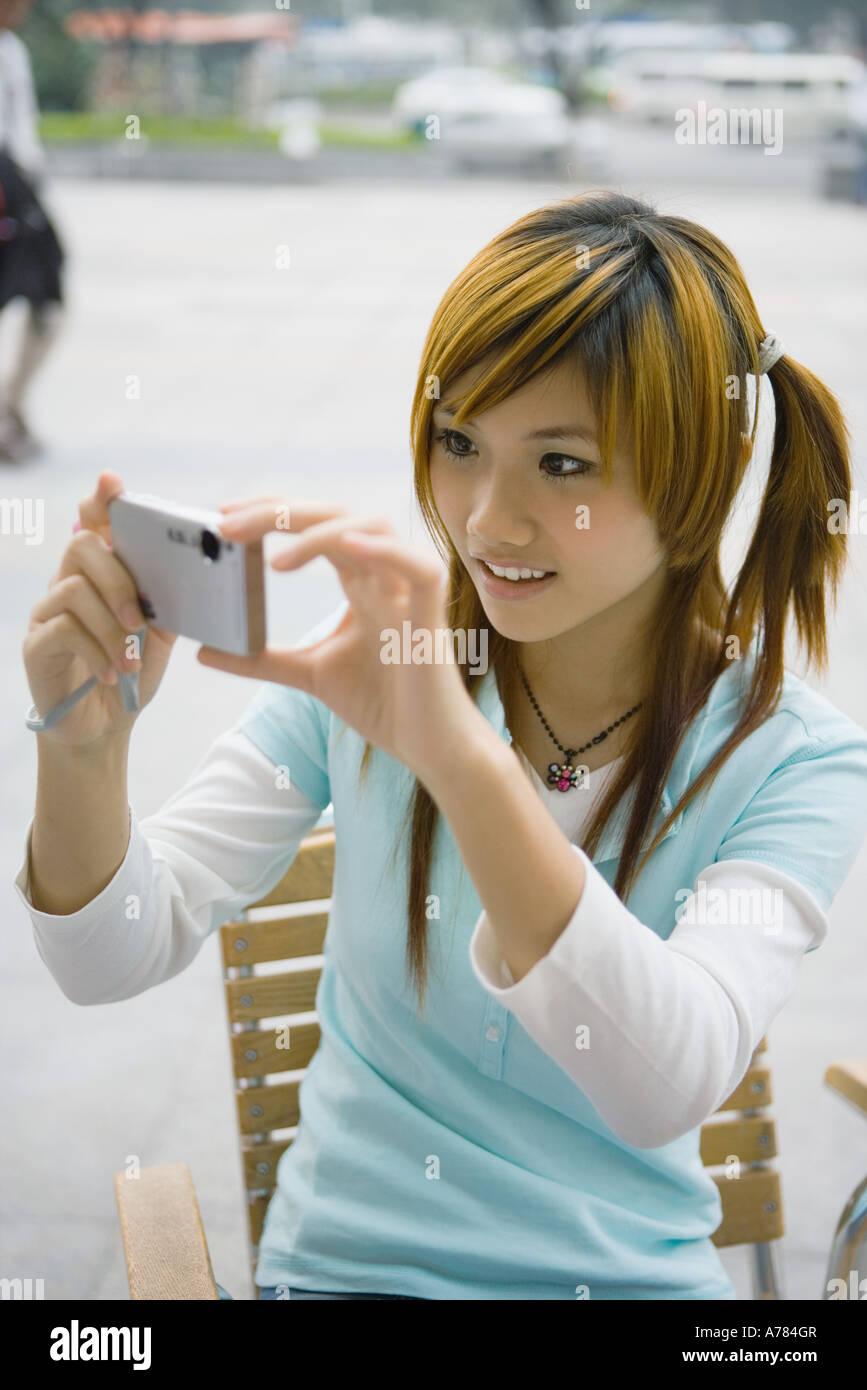 Teenage girl using digital camera Stock Photo - Alamy