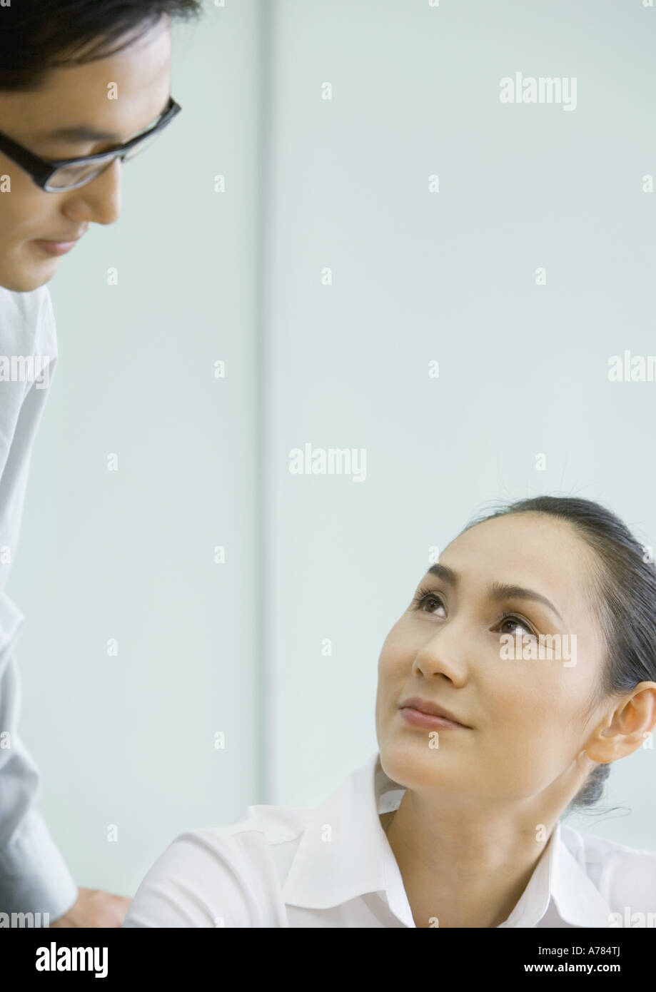 Woman sitting, smiling up at man, cropped view Stock Photo - Alamy