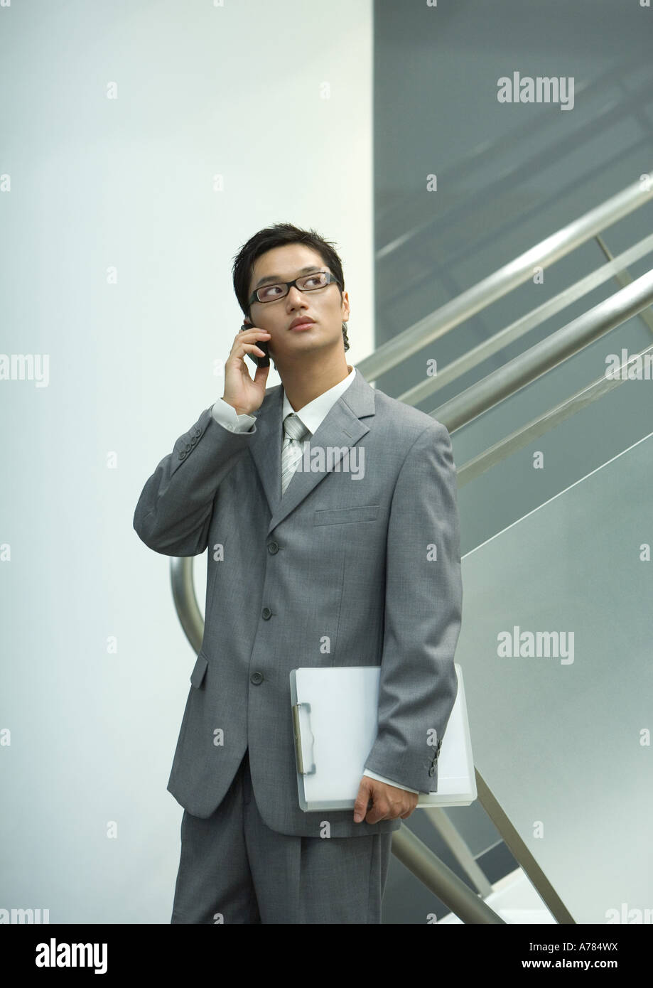 Chinese businessman holding clipboard hi-res stock photography and ...