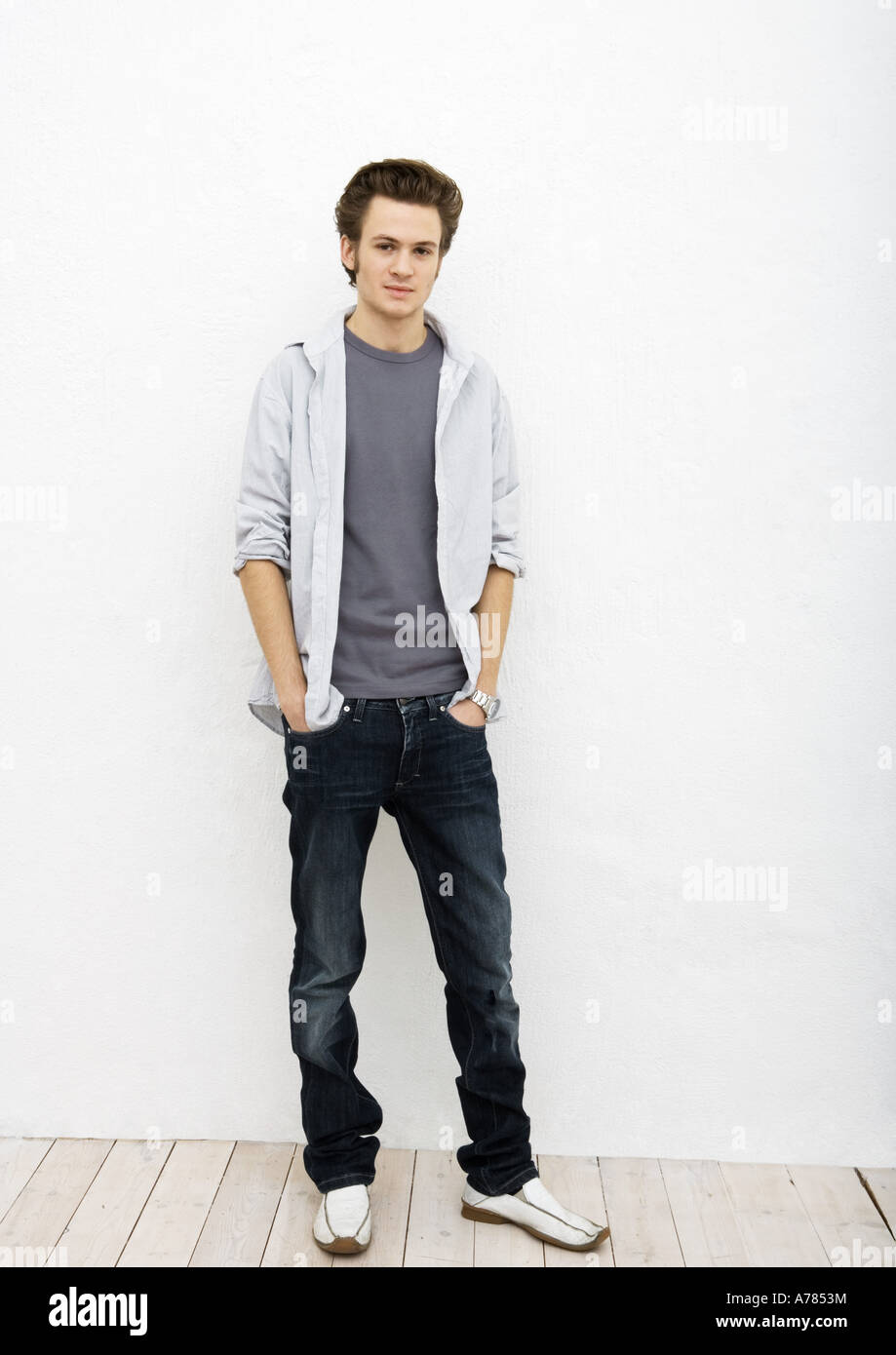Young man standing with hands in pockets, full length portrait Stock ...