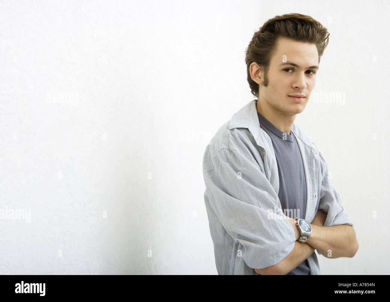 Young man with arms folded, portrait Stock Photo - Alamy