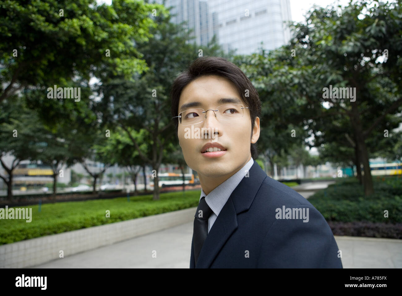 Businessman looking over shoulder Stock Photo - Alamy