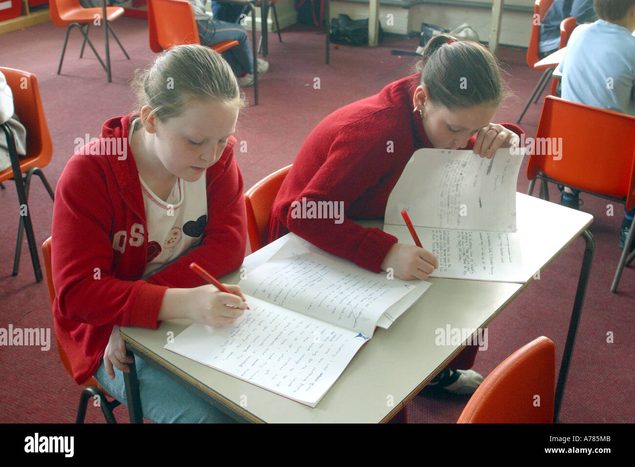 Primary school children at their desks working on a lesson Stock Photo ...