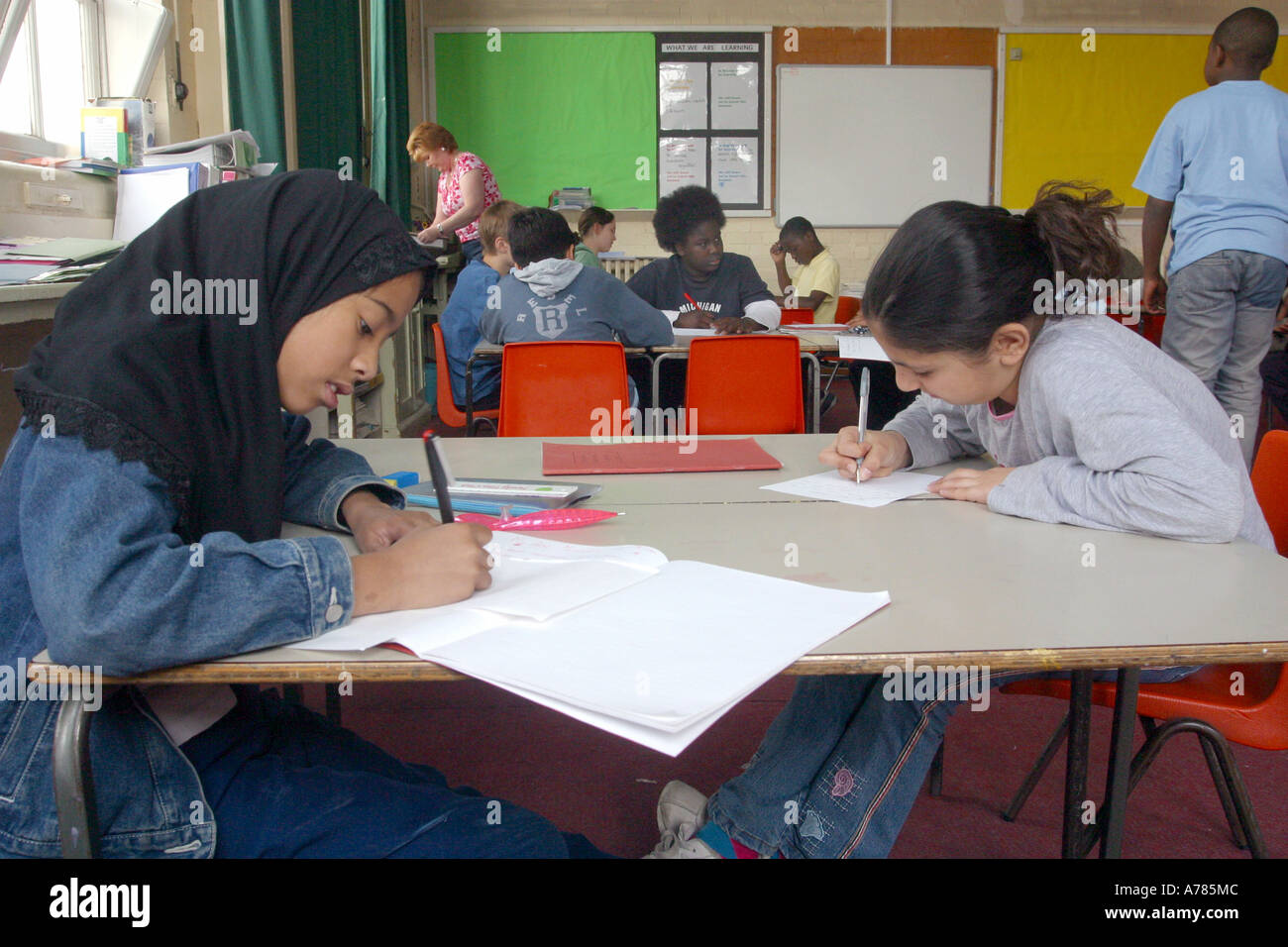 Primary school children at their desks working on a lesson Stock Photo ...