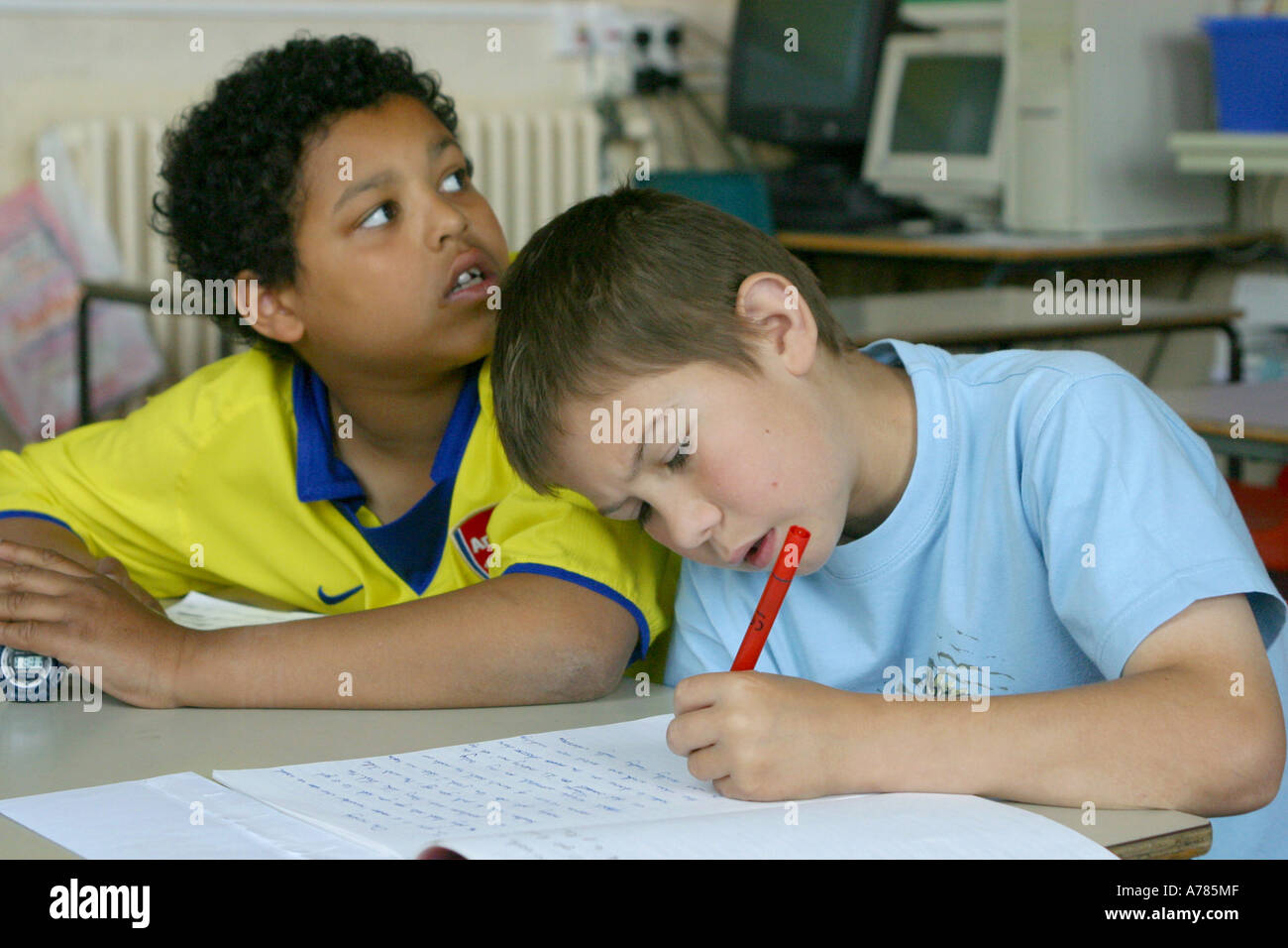Primary school boys at their desks working on a lesson Stock Photo - Alamy