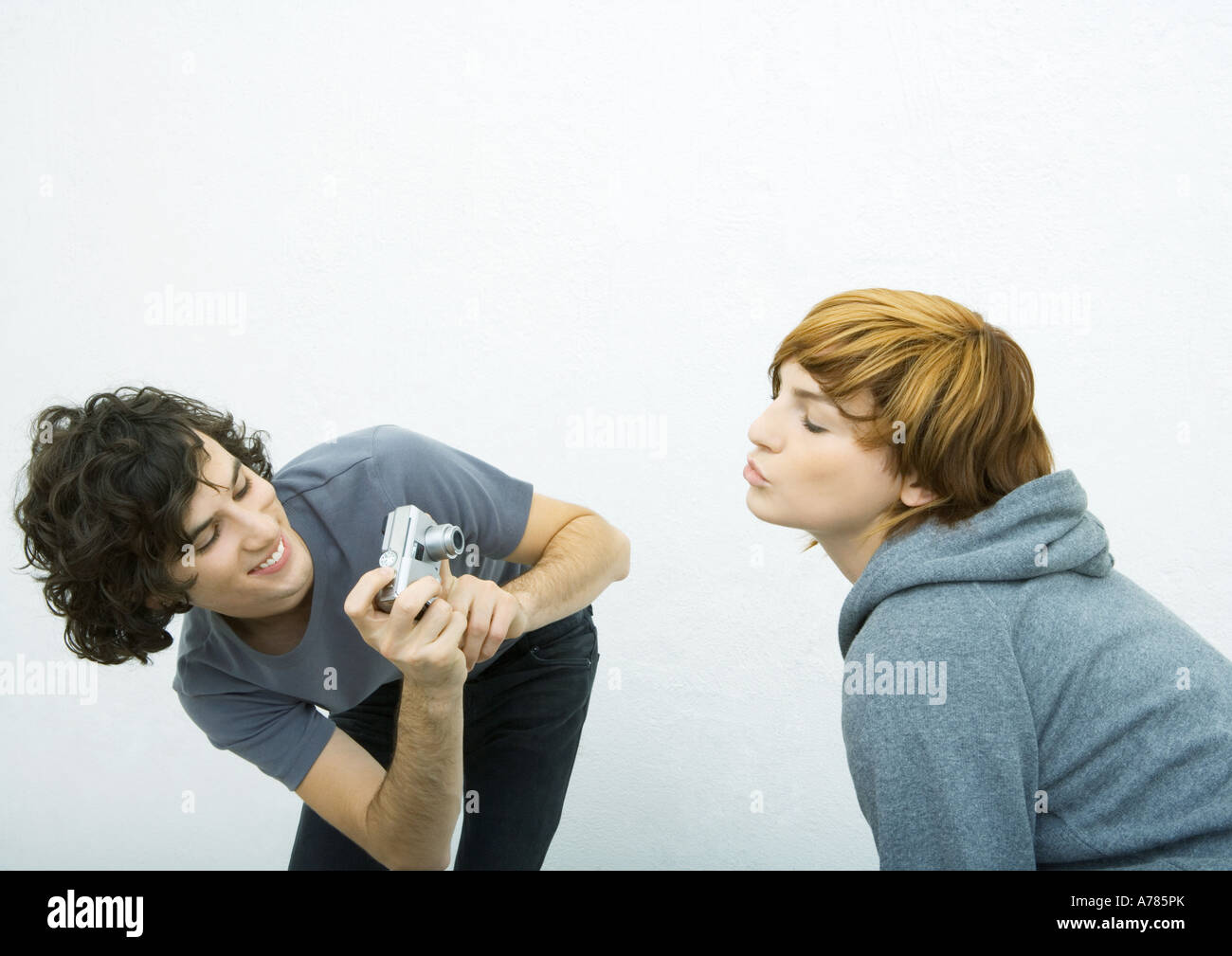 Young woman puckering while young male friend takes photo Stock Photo ...