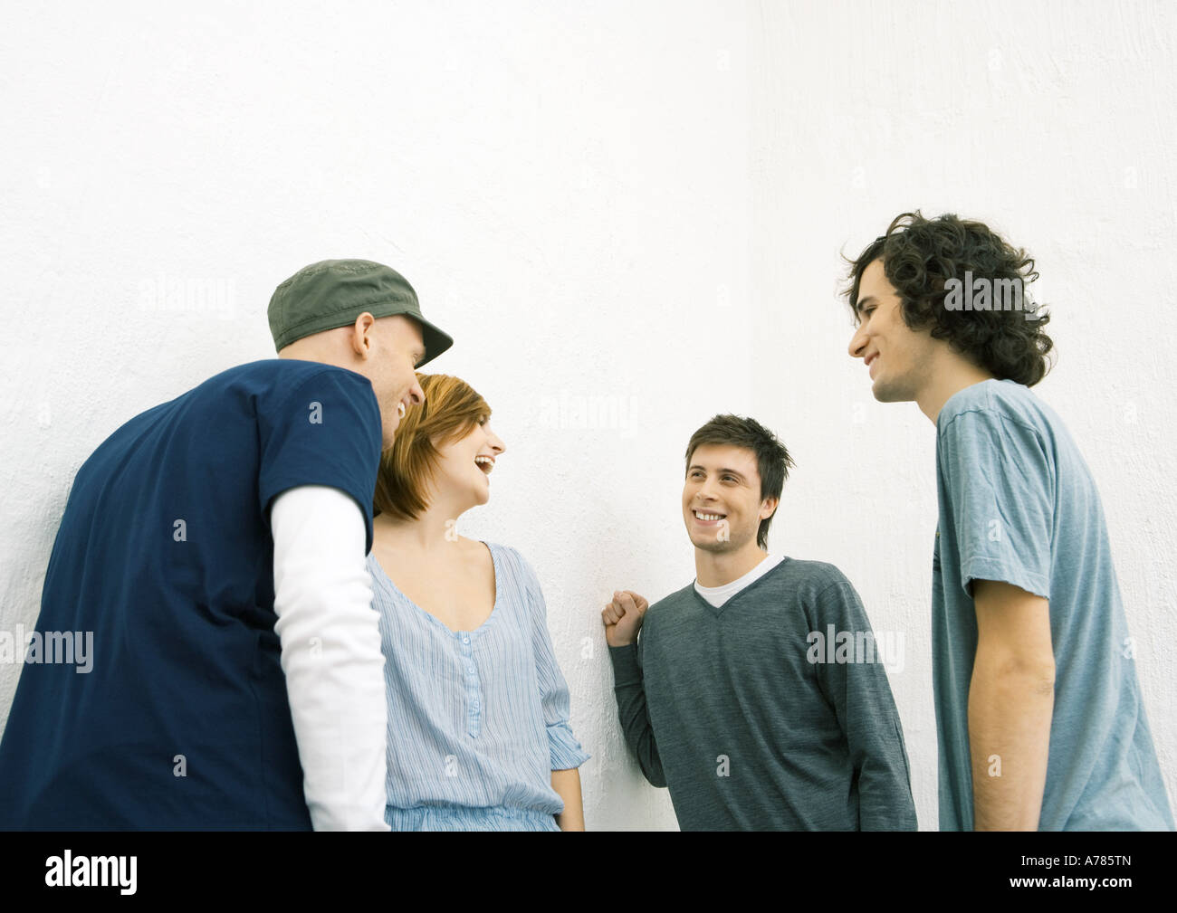 Group of young adult friends standing in group, laughing Stock Photo ...