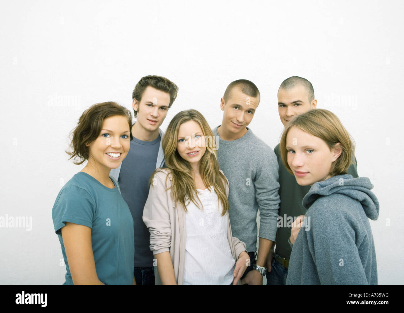 Group of young adults standing, smiling at camera Stock Photo - Alamy