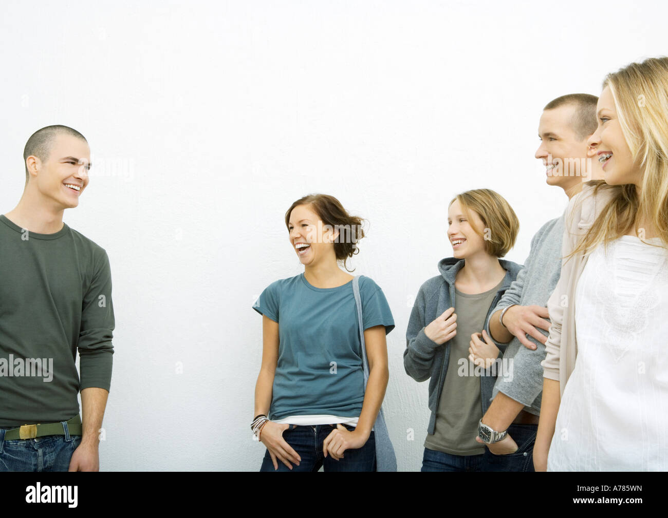 Group of young adults standing, laughing Stock Photo - Alamy