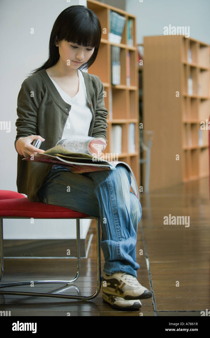 Young woman studying in library Stock Photo - Alamy