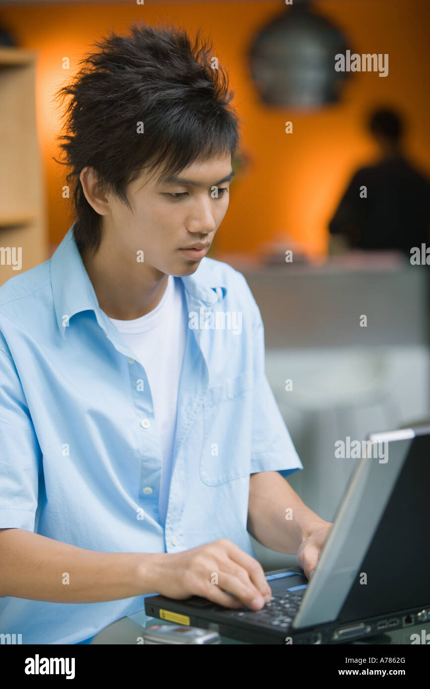 Young man using laptop Stock Photo - Alamy