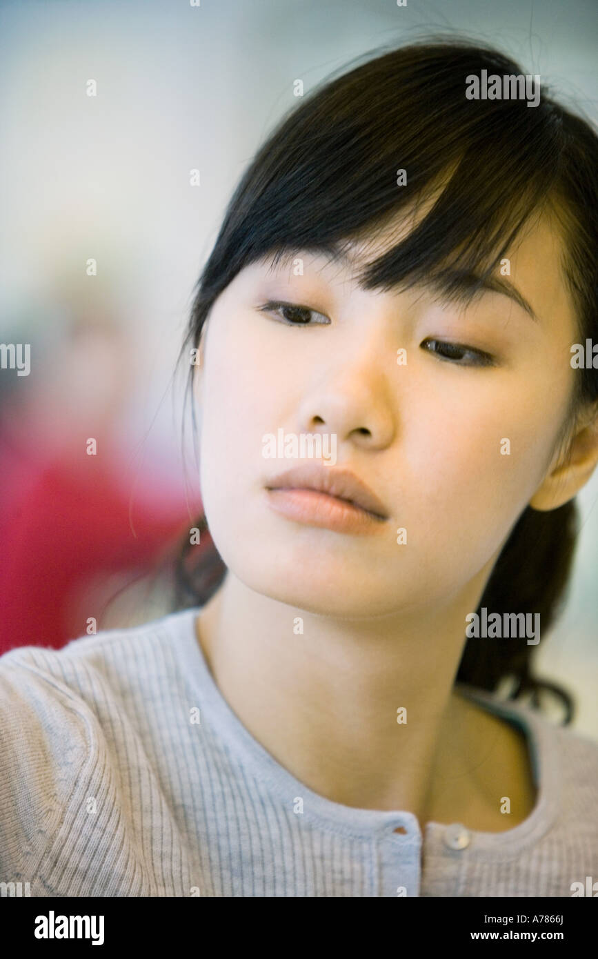 Young woman looking down, portrait Stock Photo - Alamy