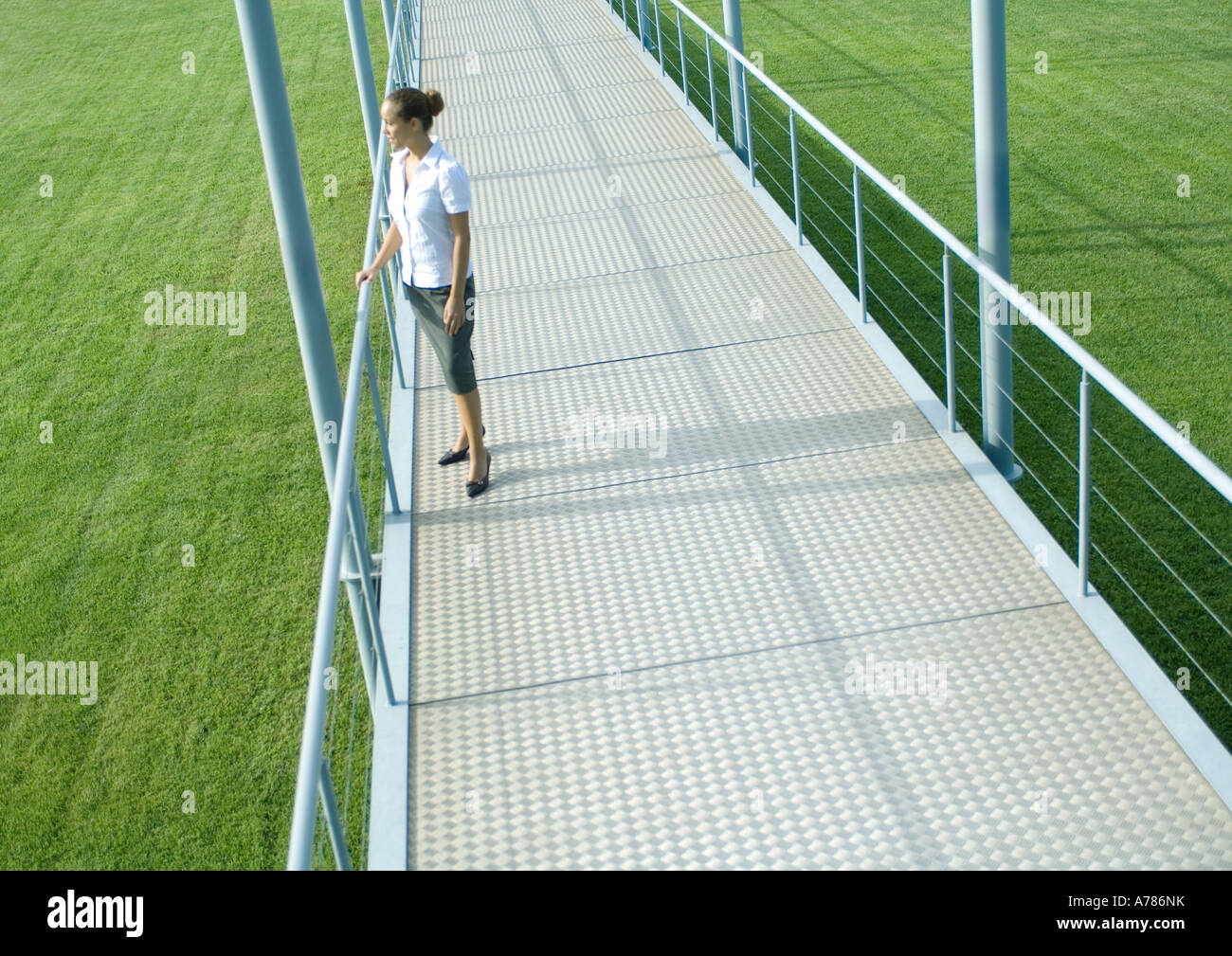 Woman standing on walkway, full length, high angle view Stock Photo - Alamy