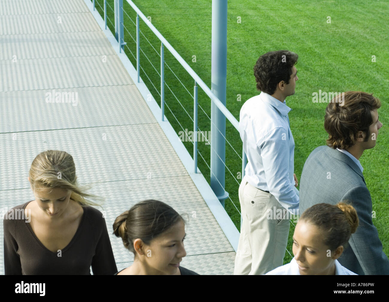People standing and walking on walkway Stock Photo - Alamy