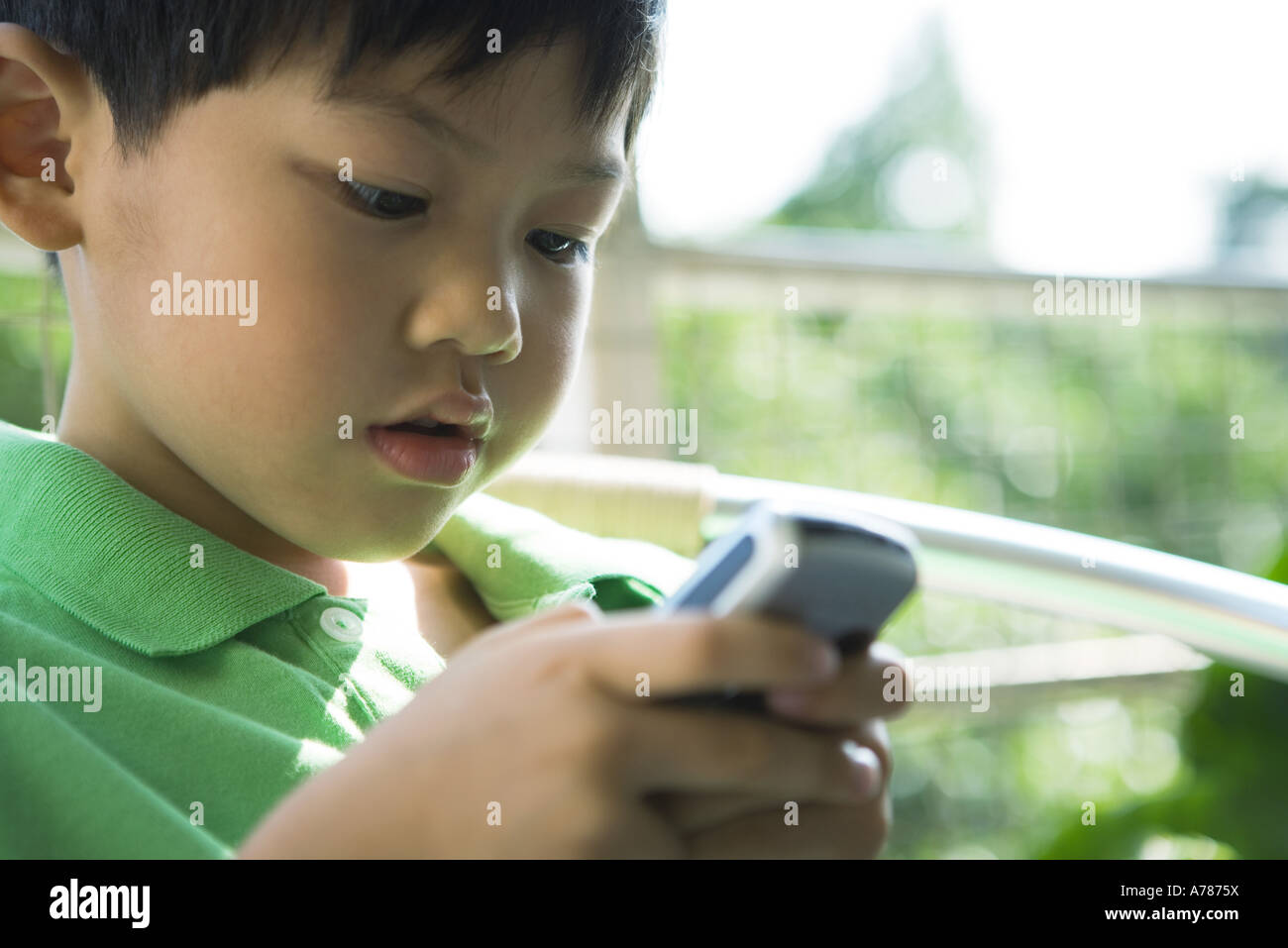 Boy holding cell phone, close-up Stock Photo - Alamy