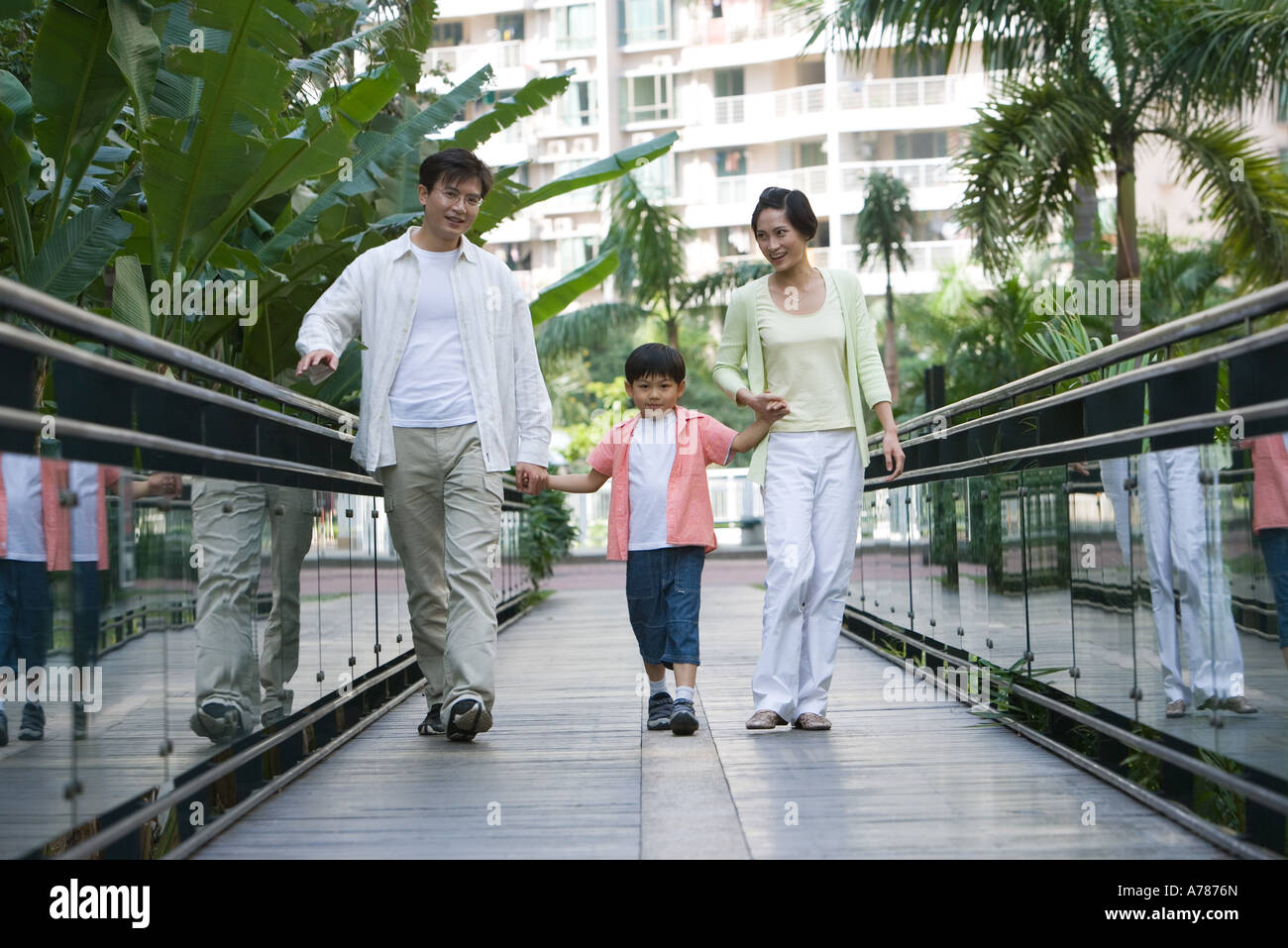 Family walking on bridge together Stock Photo - Alamy