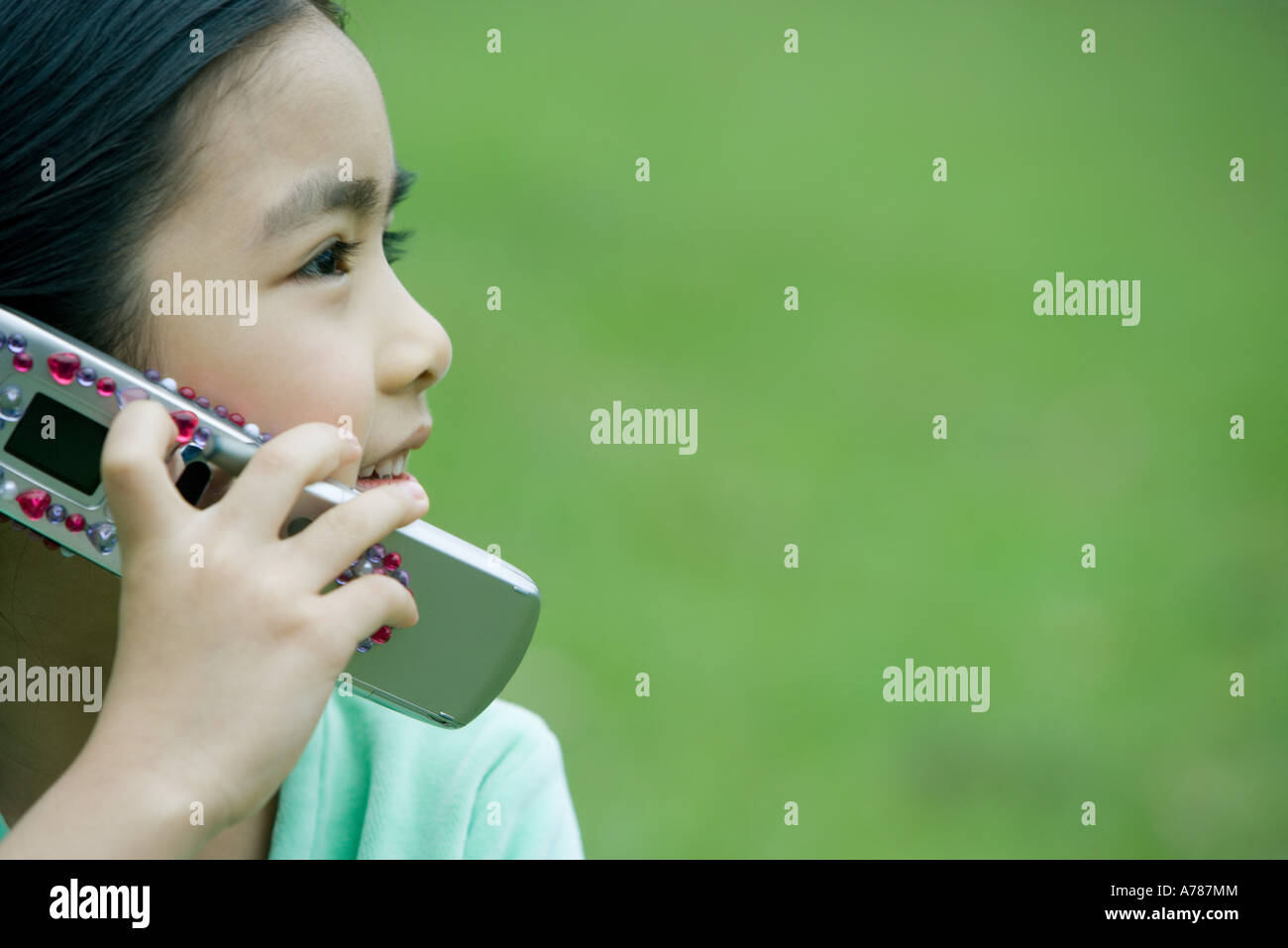 Girl using cell phone, side view, close-up Stock Photo - Alamy
