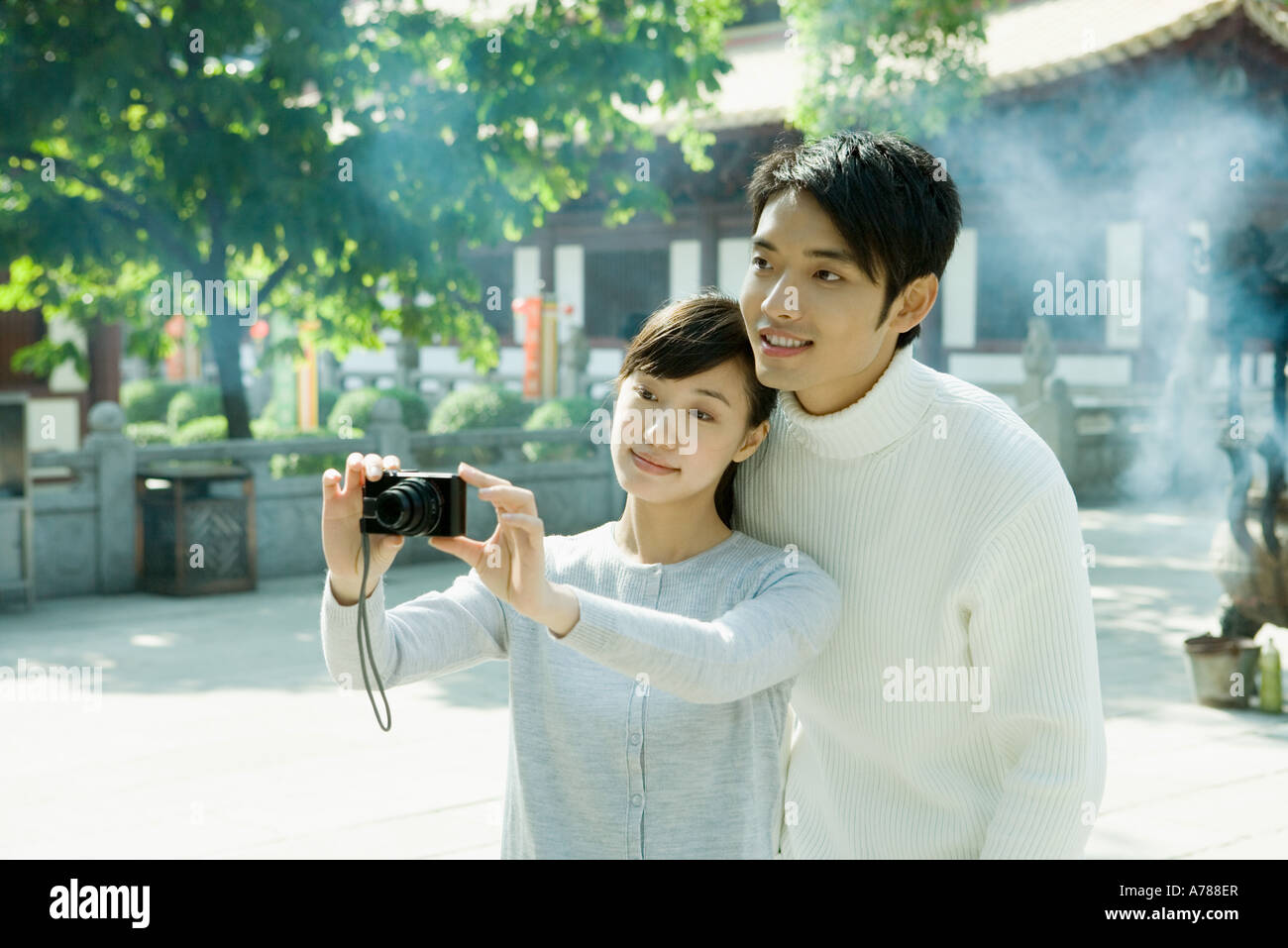 Couple taking photo, temple in background Stock Photo - Alamy