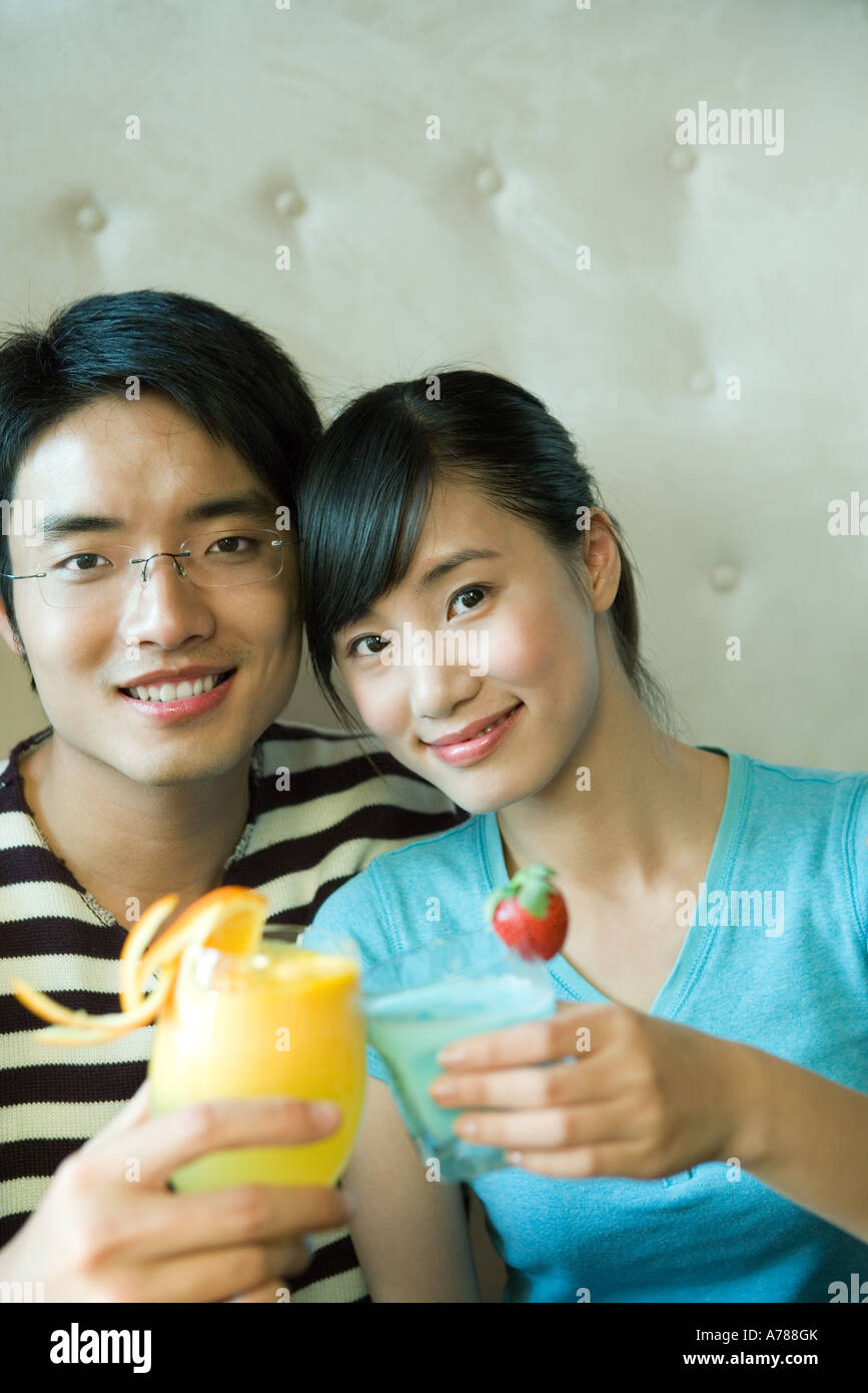 Couple raising glasses together Stock Photo - Alamy