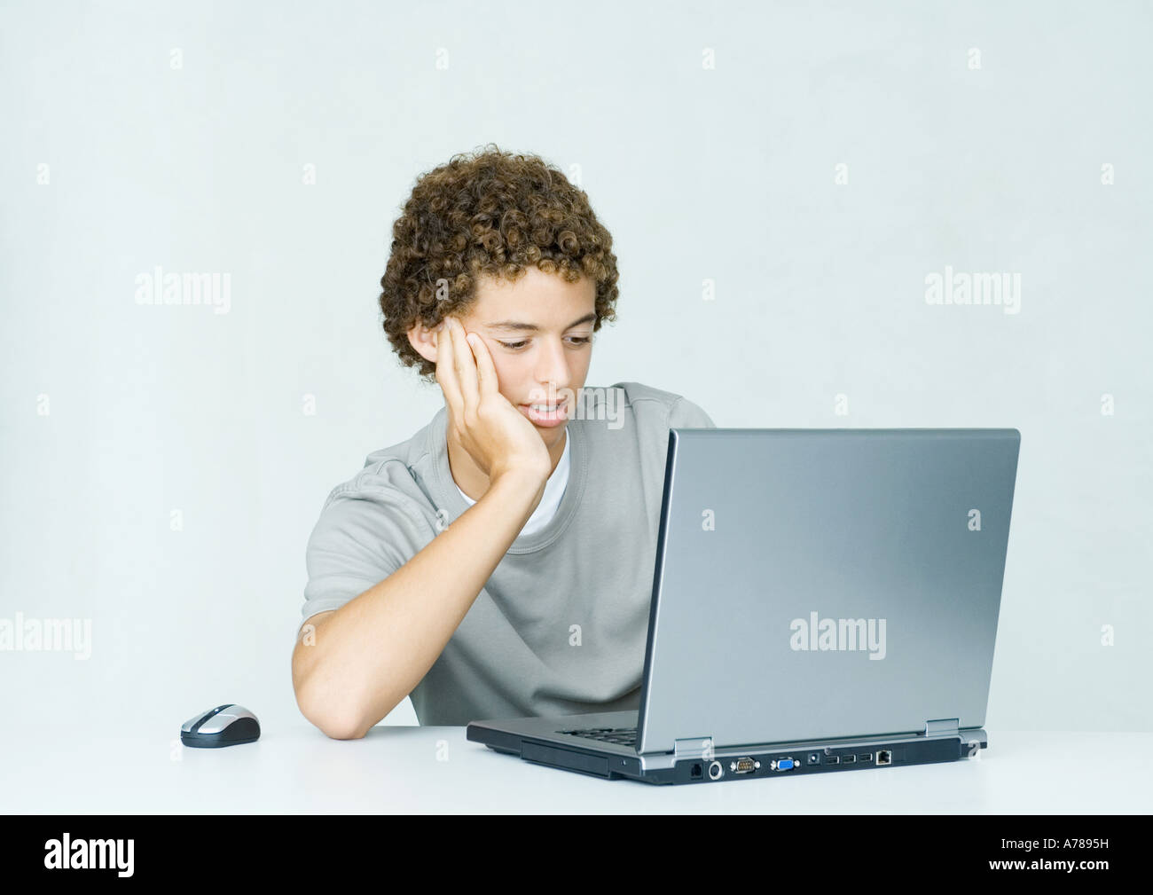 Teenage boy using laptop Stock Photo - Alamy