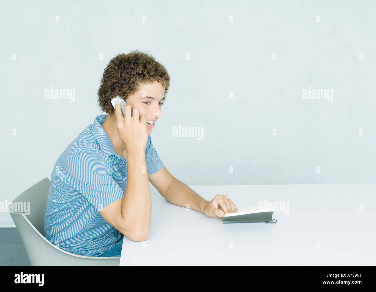 Teenage boy using cell phone Stock Photo - Alamy