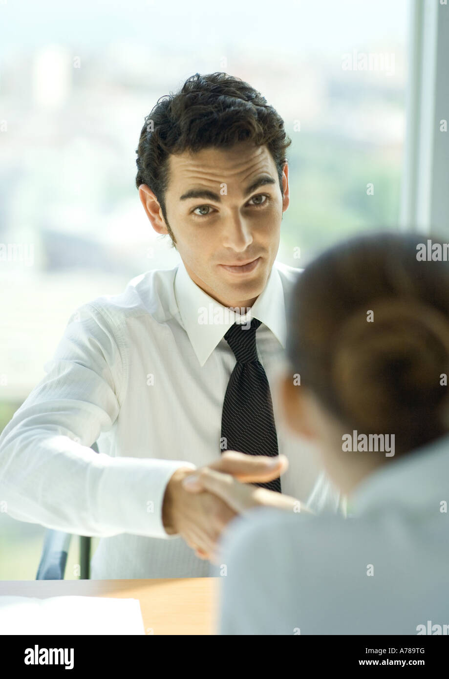 Shaking hands across table hi-res stock photography and images - Alamy
