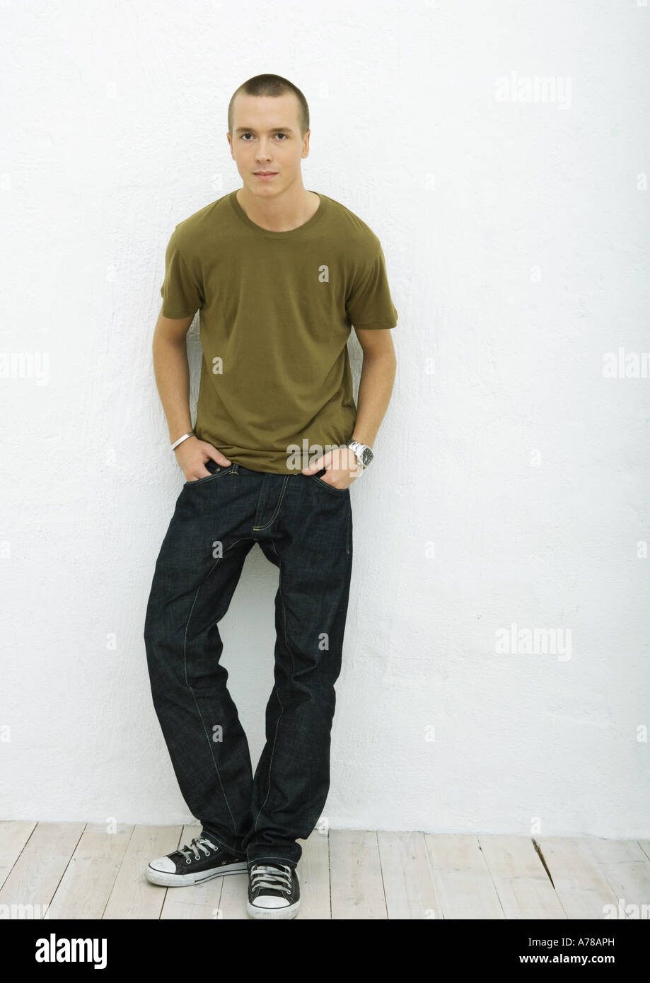 Young man standing with hands in pockets, full length portrait Stock ...