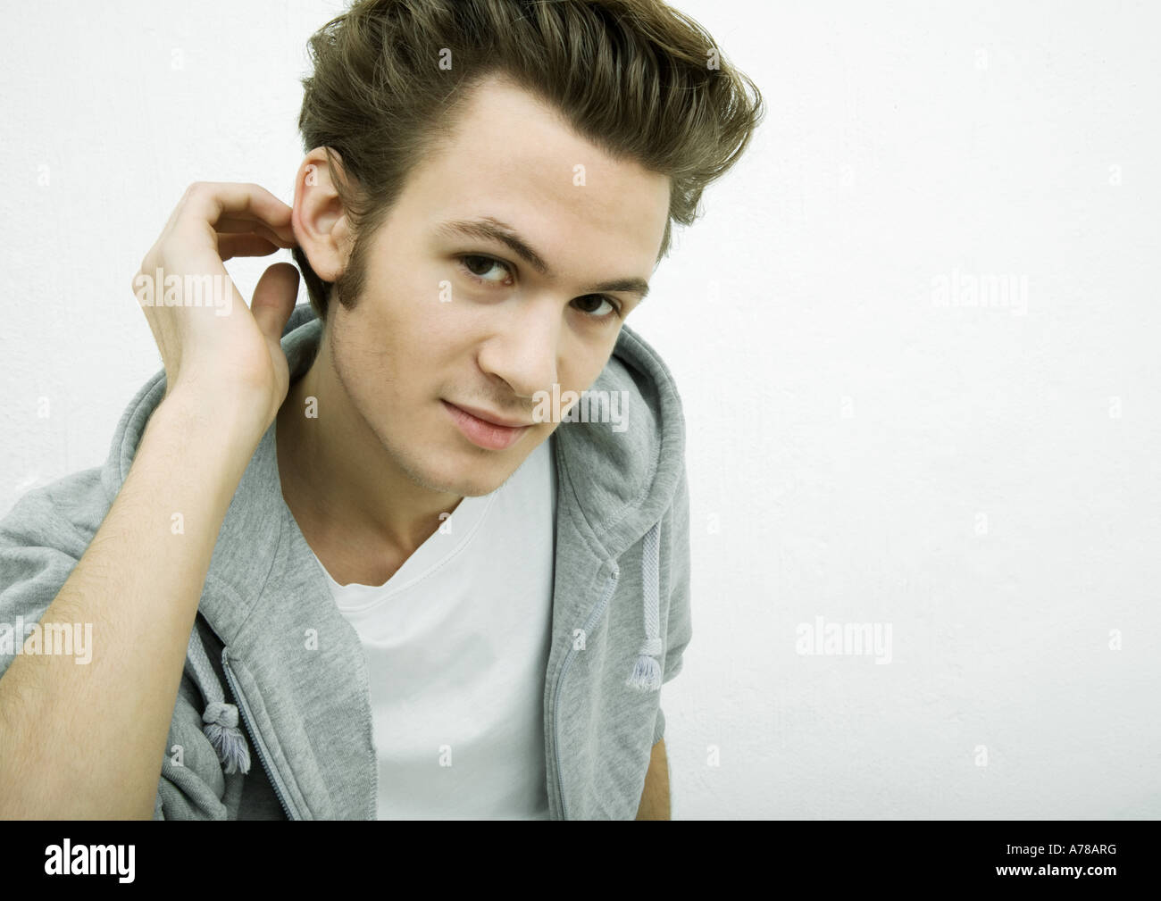 Young man leaning toward camera, portrait Stock Photo - Alamy