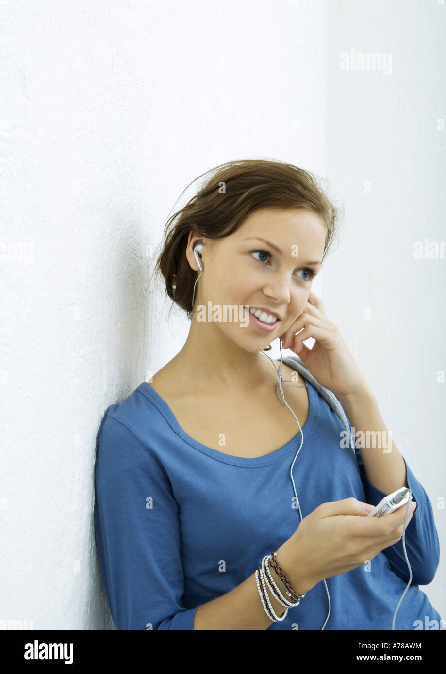 Woman smiles listening music using hi-res stock photography and images ...