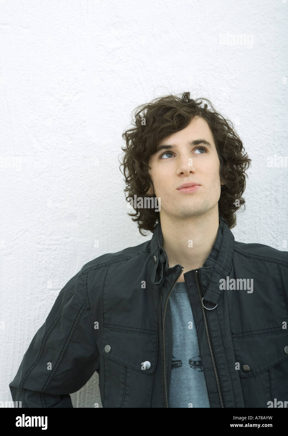 Young man looking up, portrait, white background Stock Photo - Alamy