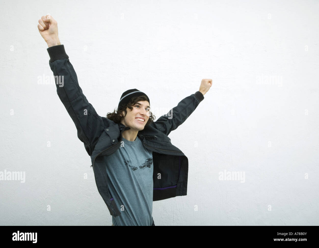Young man standing with arms out, white background Stock Photo - Alamy