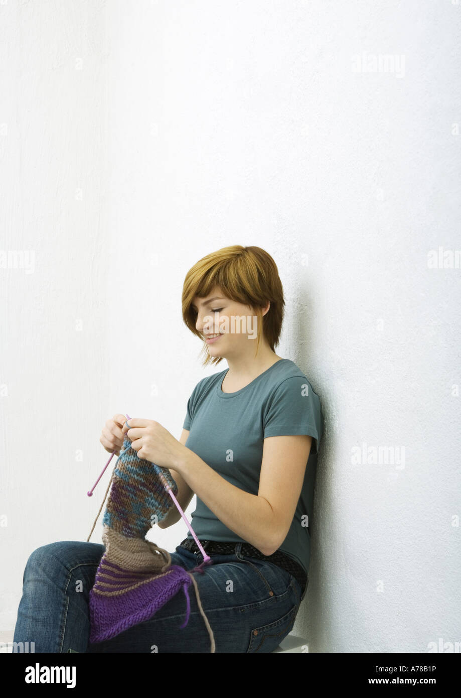 Young woman knitting, white background Stock Photo - Alamy