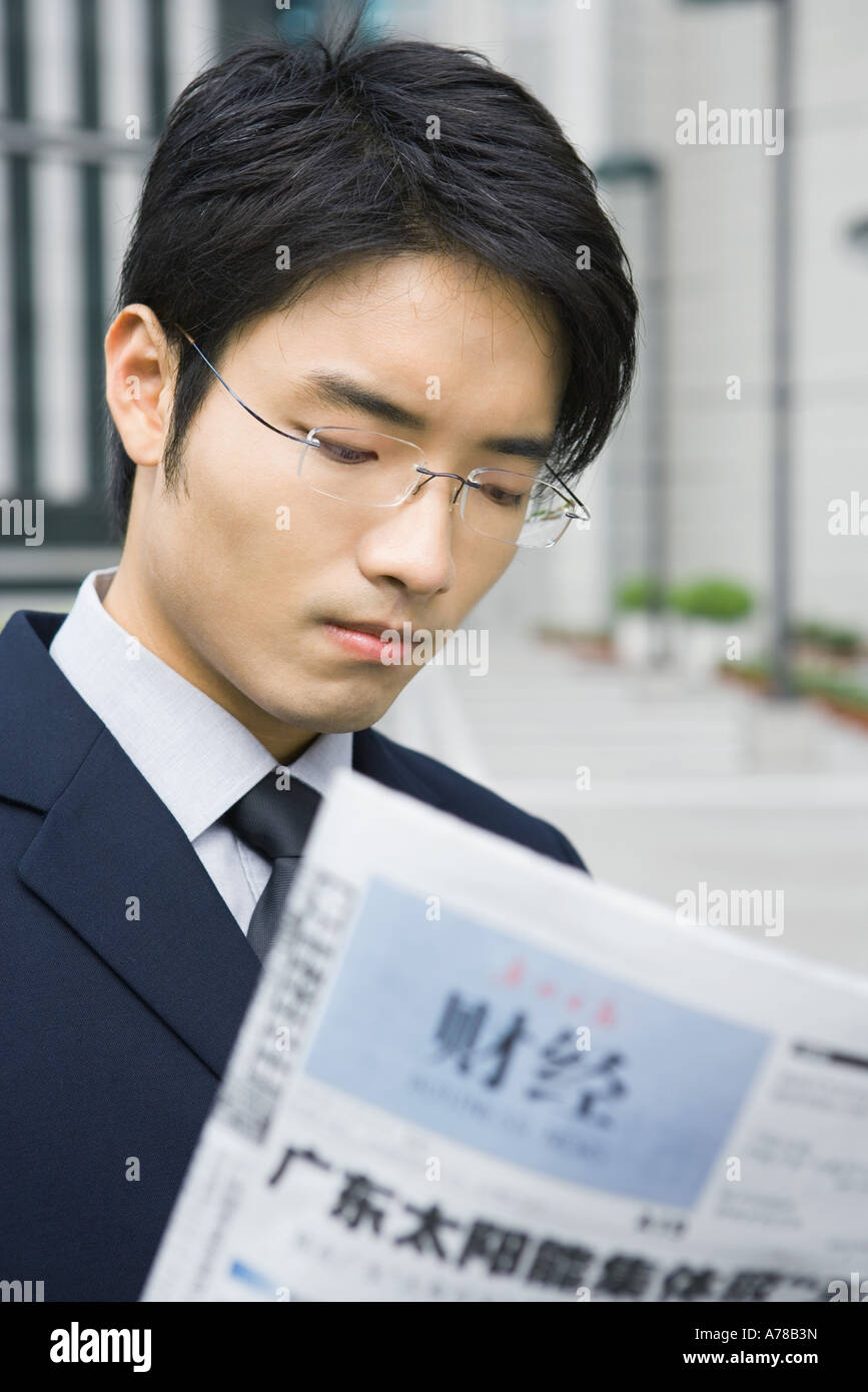 Businessman reading Chinese newspaper Stock Photo - Alamy