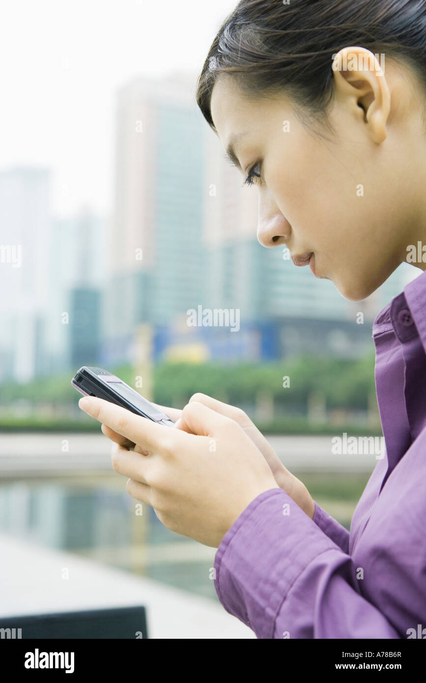 Businesswoman using messaging phone, close-up, side view Stock Photo ...