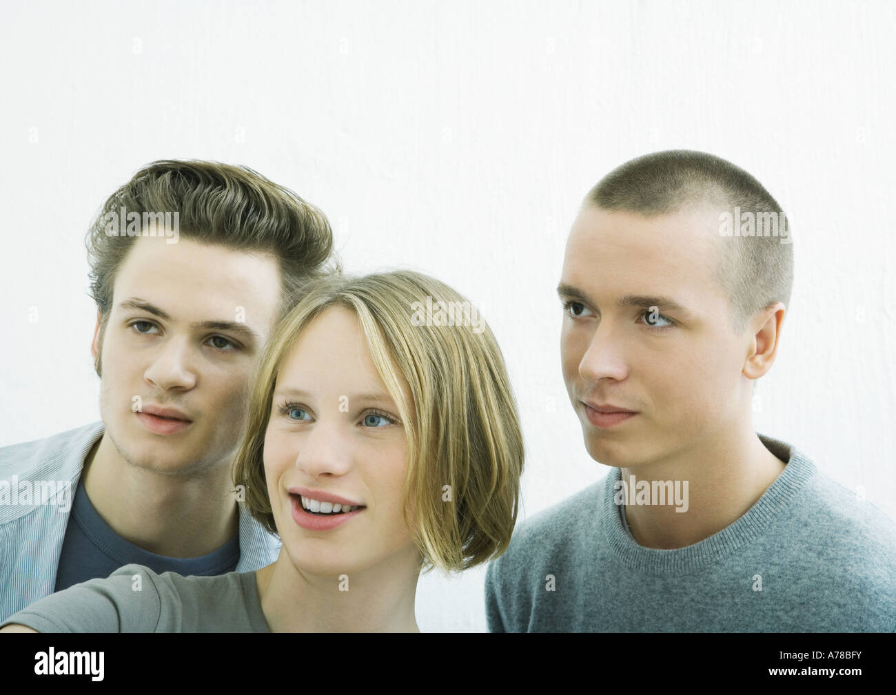 Three young friends, looking out of frame Stock Photo - Alamy