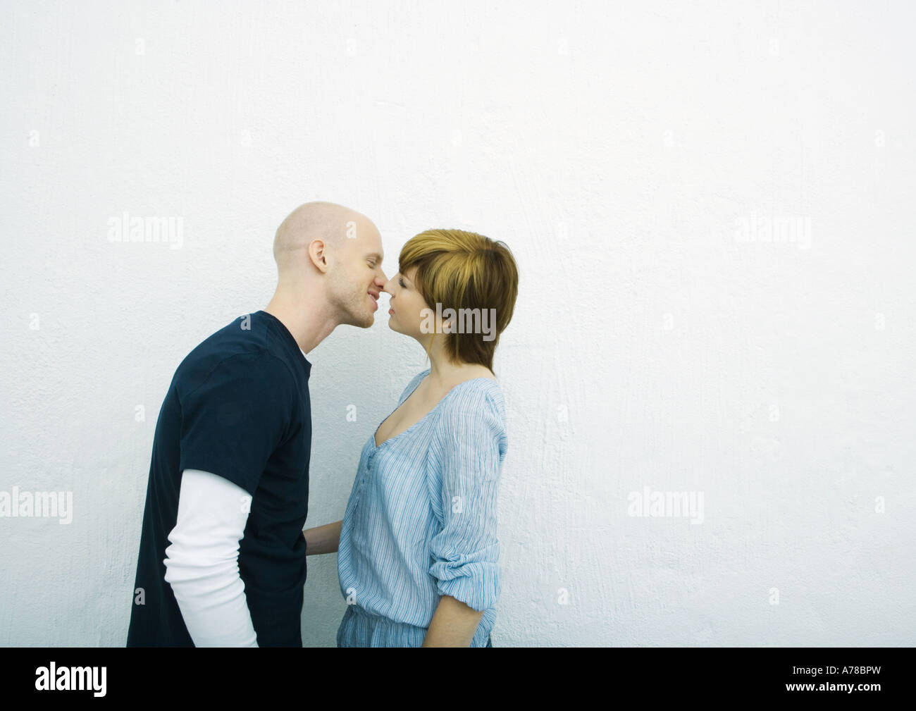 Young couple kissing, side view Stock Photo - Alamy