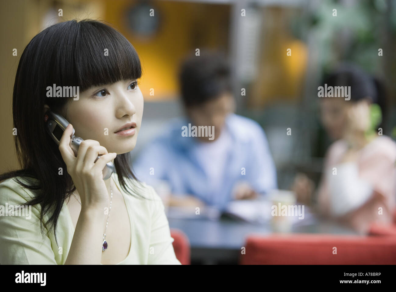 Young woman using cell phone Stock Photo - Alamy